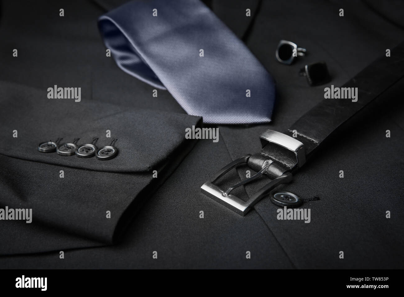 Elegant tie, cuff links and belt on male jacket, closeup Stock Photo ...