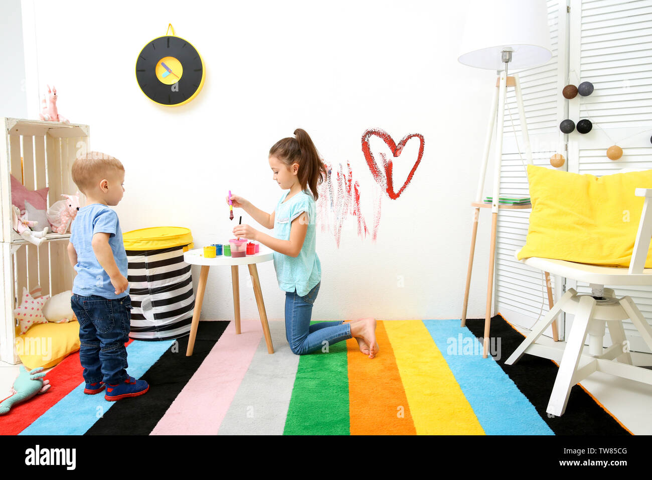 Little children painting on wall at home Stock Photo - Alamy