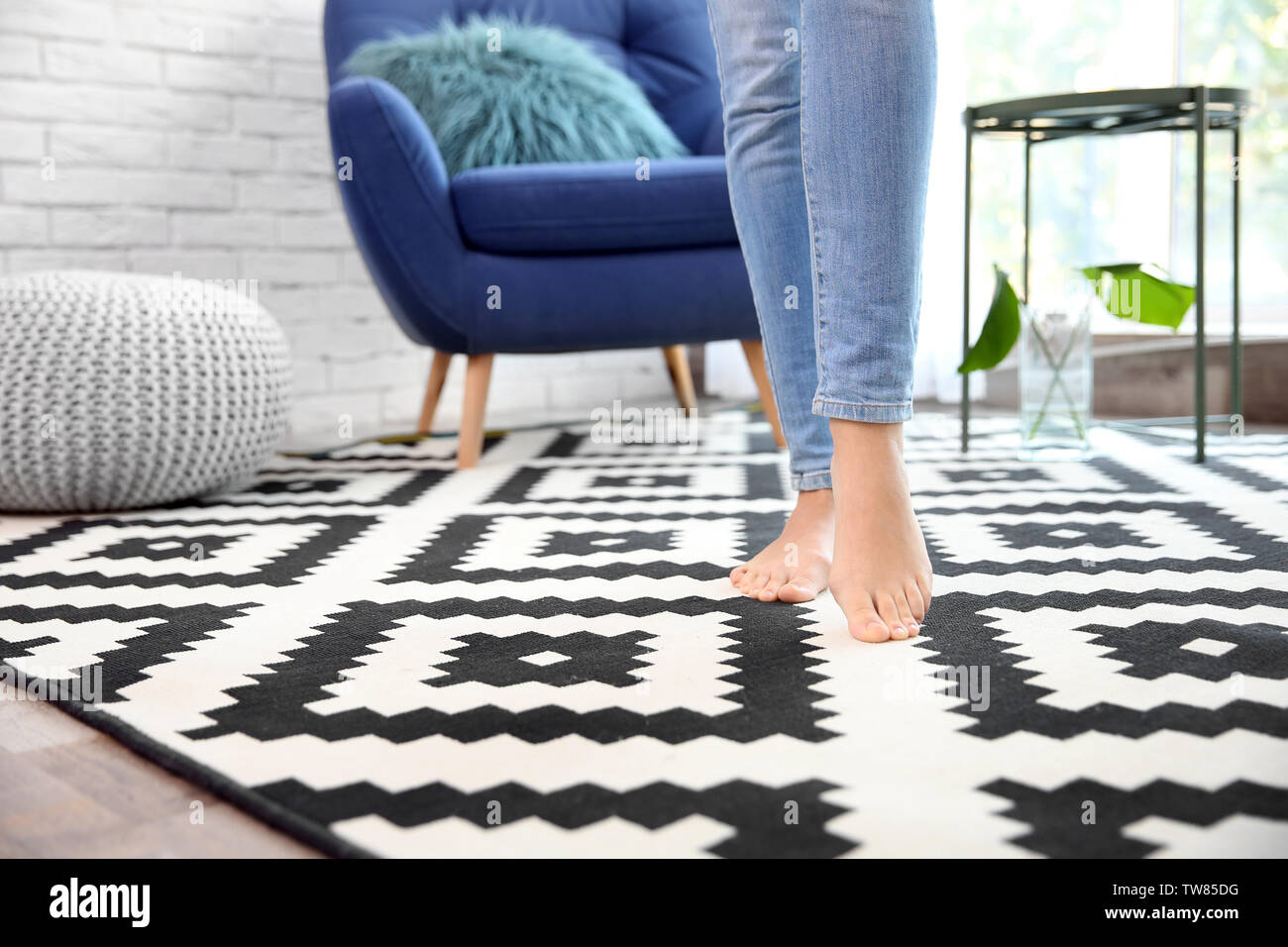 Woman walking on carpet at home Stock Photo - Alamy