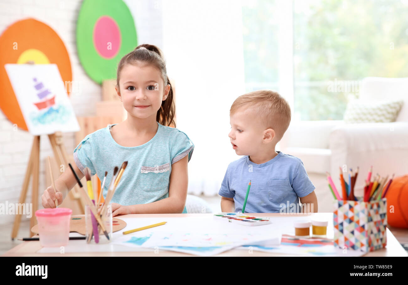 Little children drawing at table indoors Stock Photo - Alamy