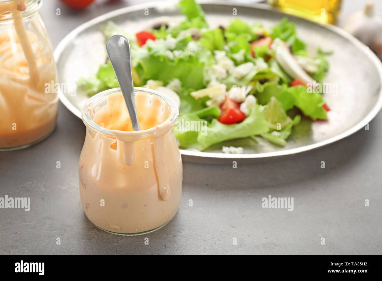 Glass jar with ranch salad dressing on table Stock Photo - Alamy