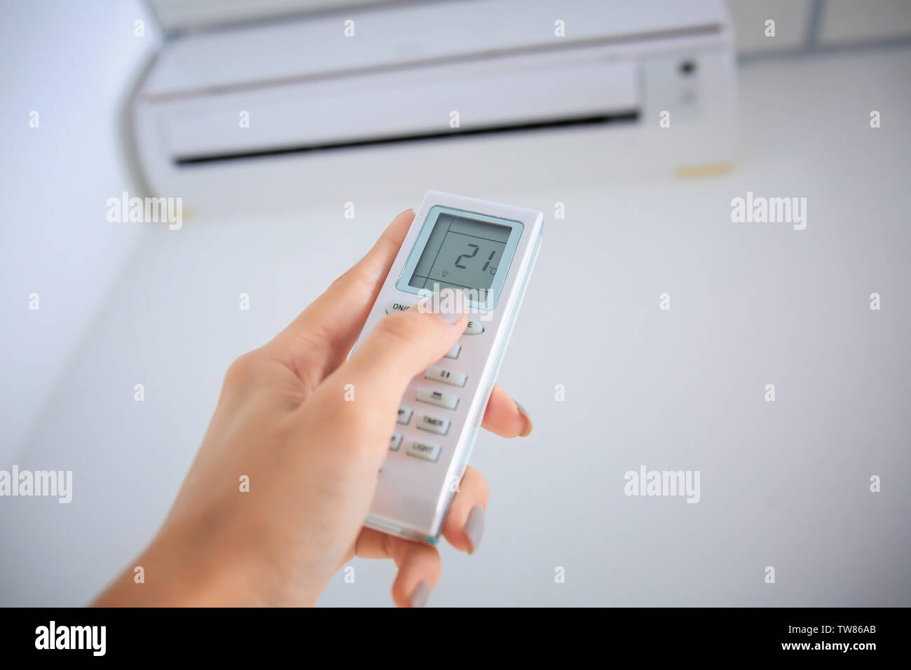 Woman and pointing remote control hi-res stock photography and images ...