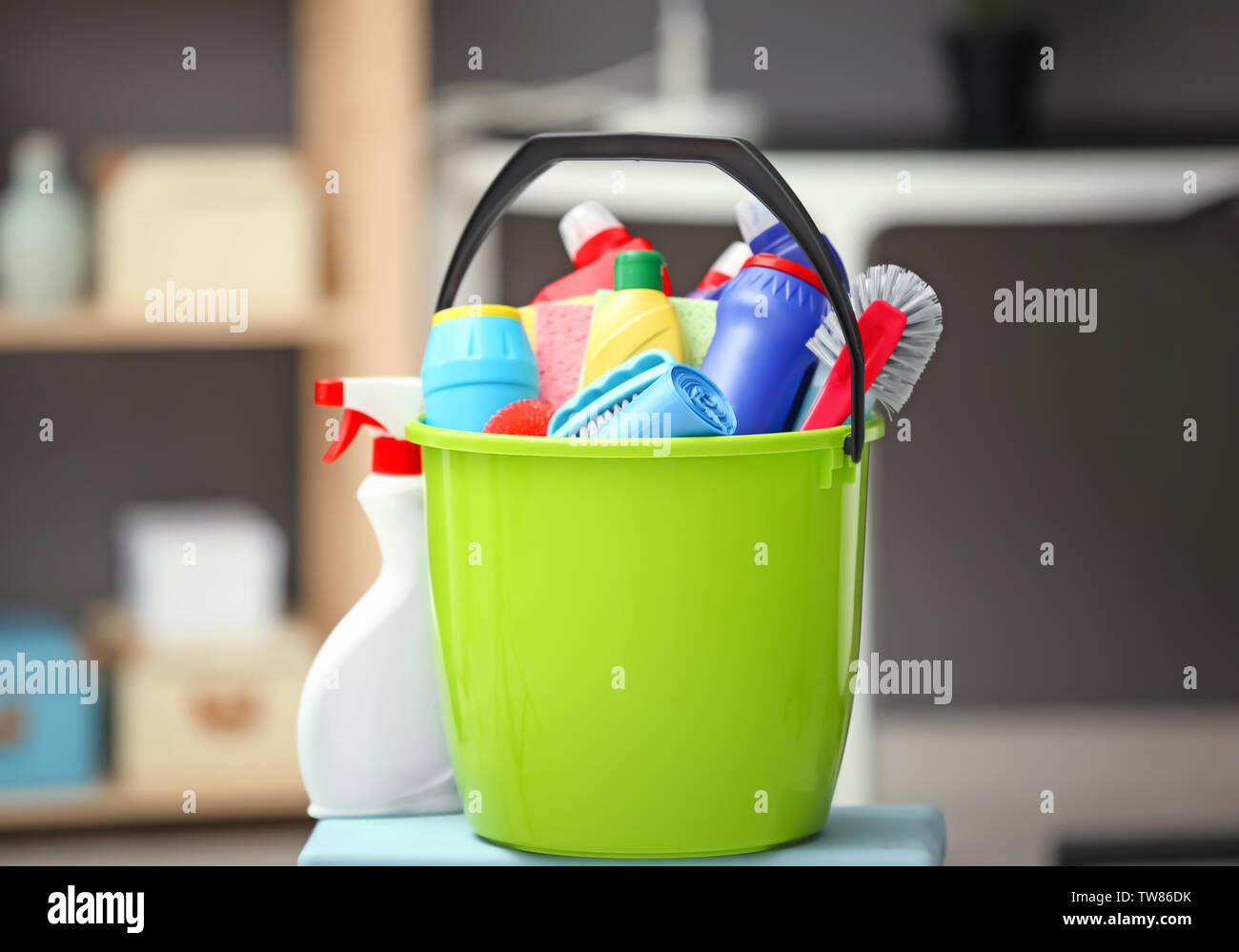 Bucket with cleaning products and tools on blurred background Stock ...