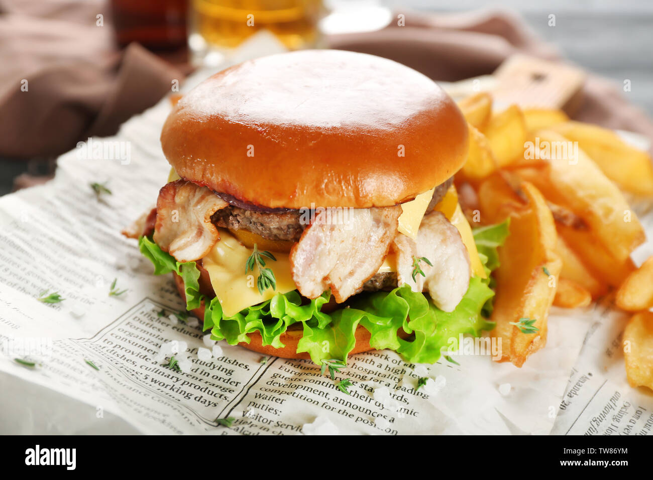 Tasty double burger on newspaper, closeup Stock Photo - Alamy