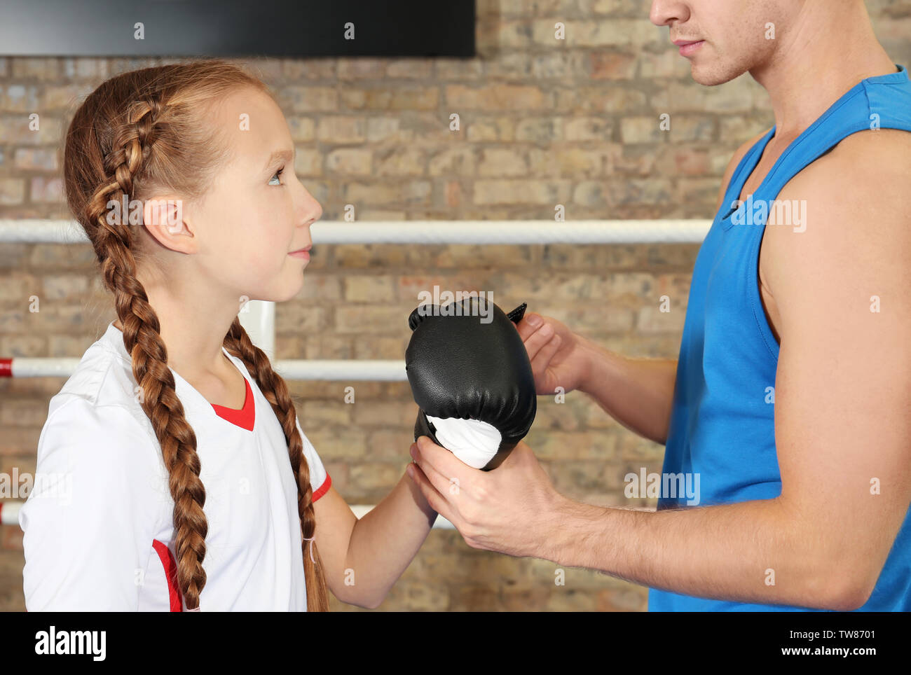 Little girl with trainer on boxing ring Stock Photo - Alamy