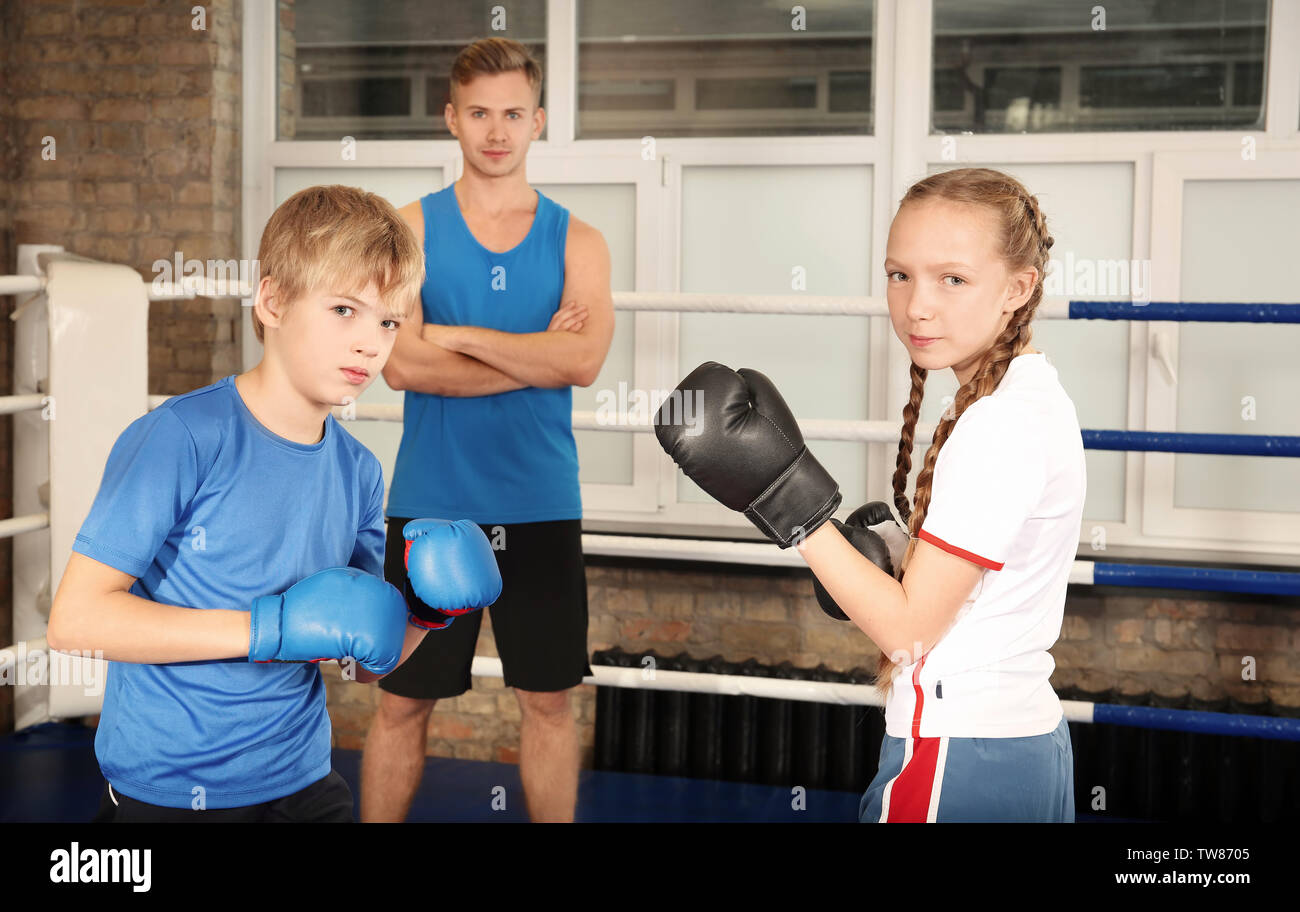Little boy and girl fighting on boxing ring Stock Photo - Alamy