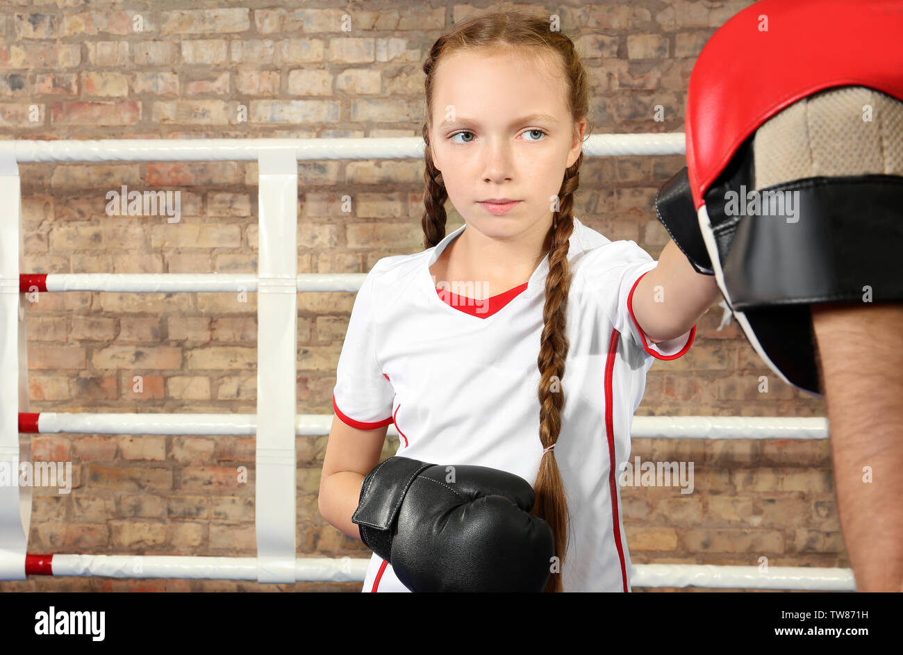 Little girl with trainer on boxing ring Stock Photo - Alamy