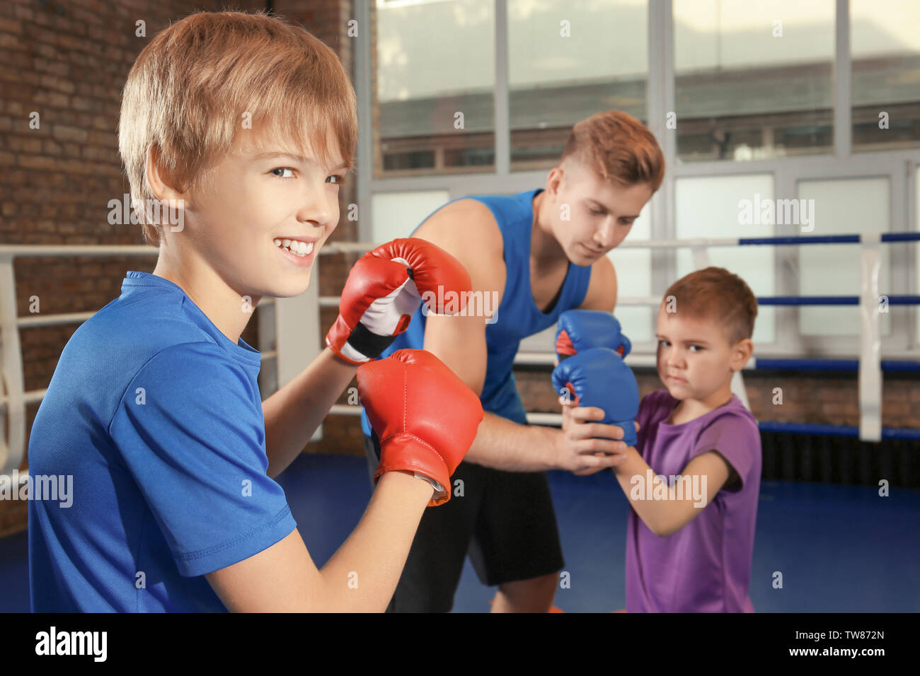 Little boys with trainer on boxing ring Stock Photo - Alamy