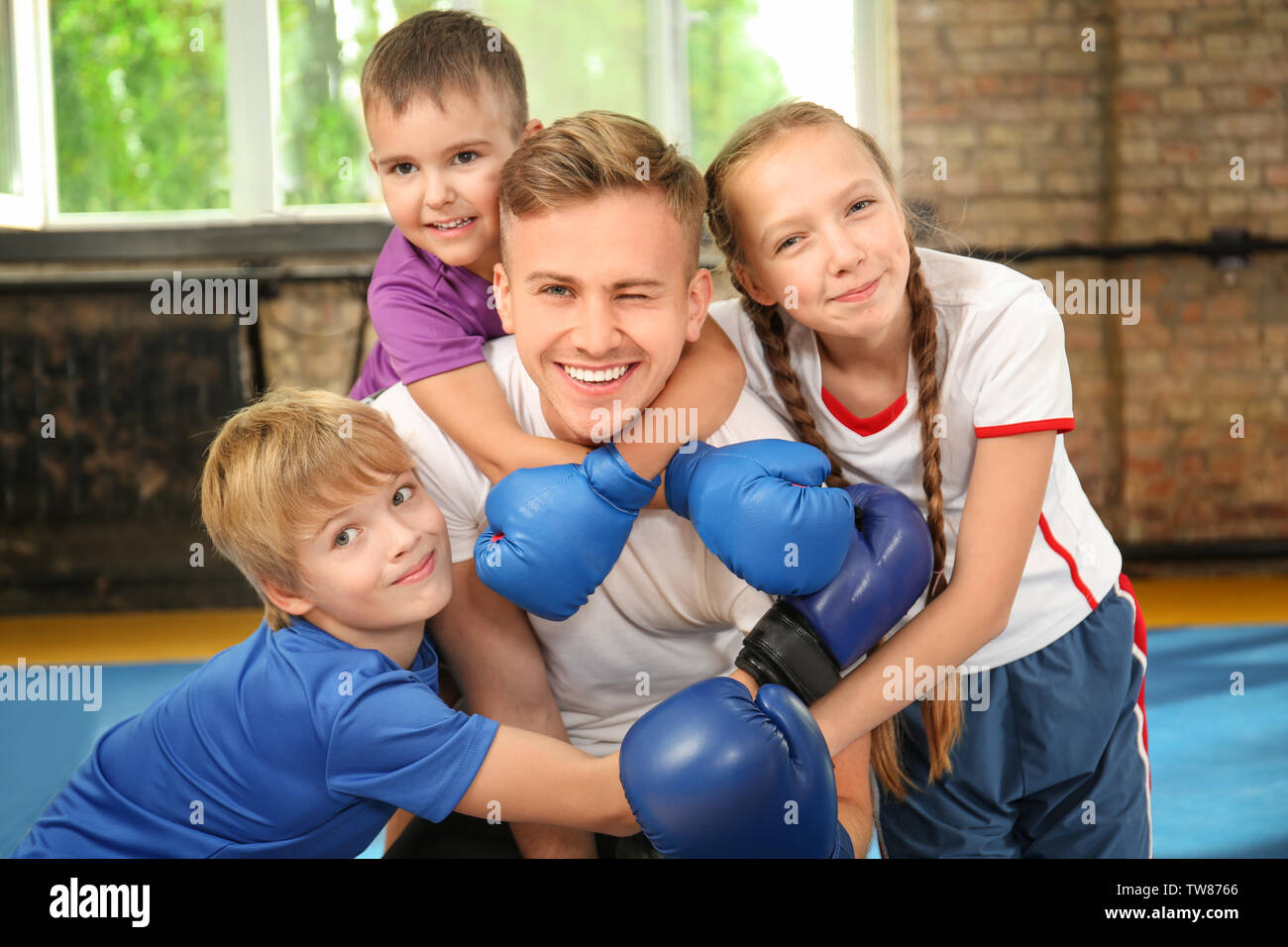 Little children in boxing gloves with trainer indoors Stock Photo - Alamy