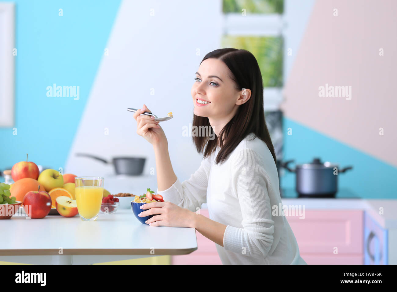 Young woman eating porridge table hi-res stock photography and images ...
