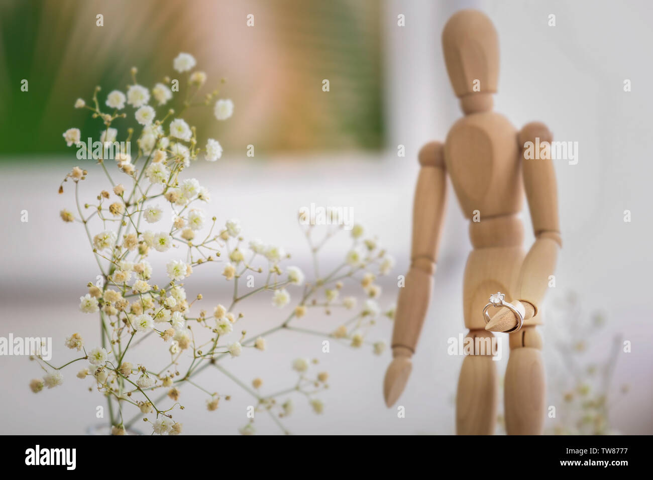 Wooden small mannequin with engagement ring on blurred background Stock ...