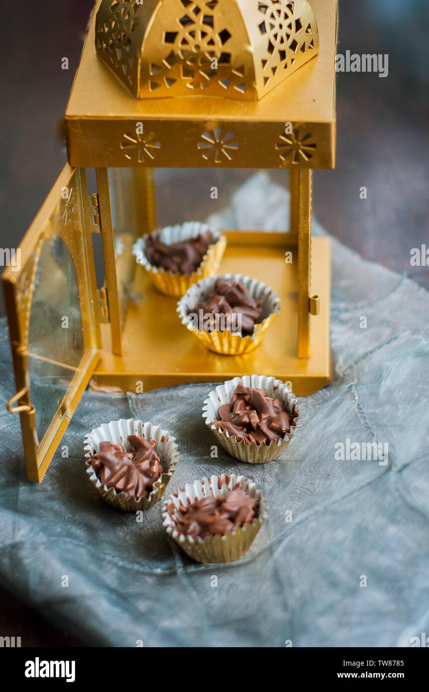 Chocolate Covered Almonds in golden paper cups with golden lighthouse ...