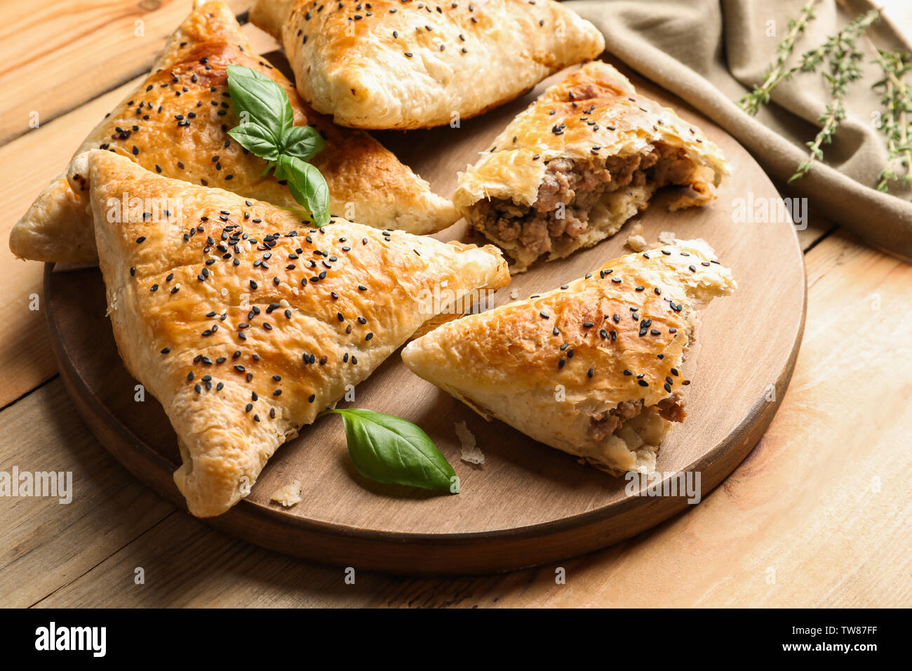 Wooden board with delicious meat samosas on table Stock Photo - Alamy