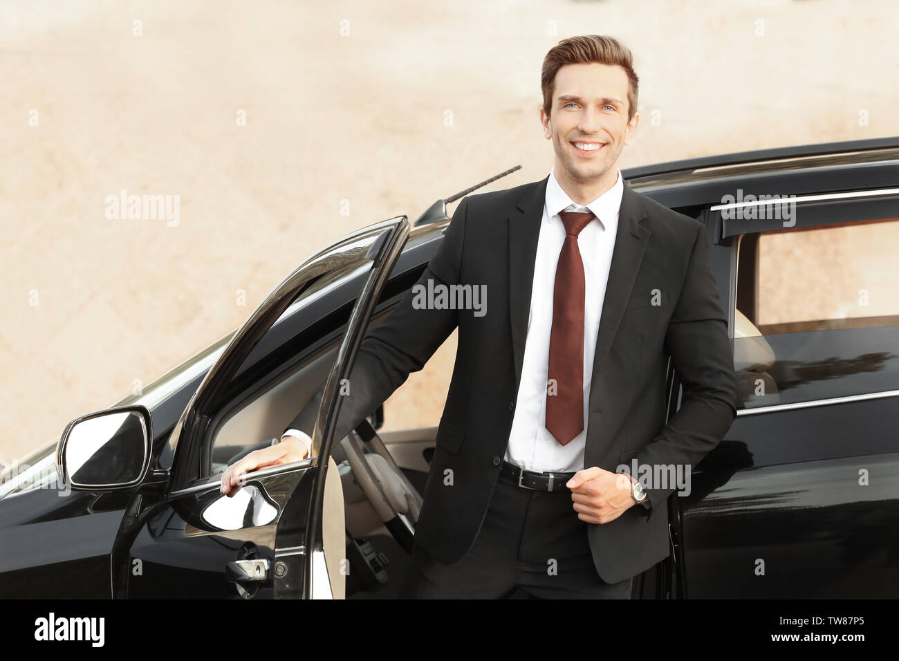 Man in formal wear getting out of car Stock Photo - Alamy