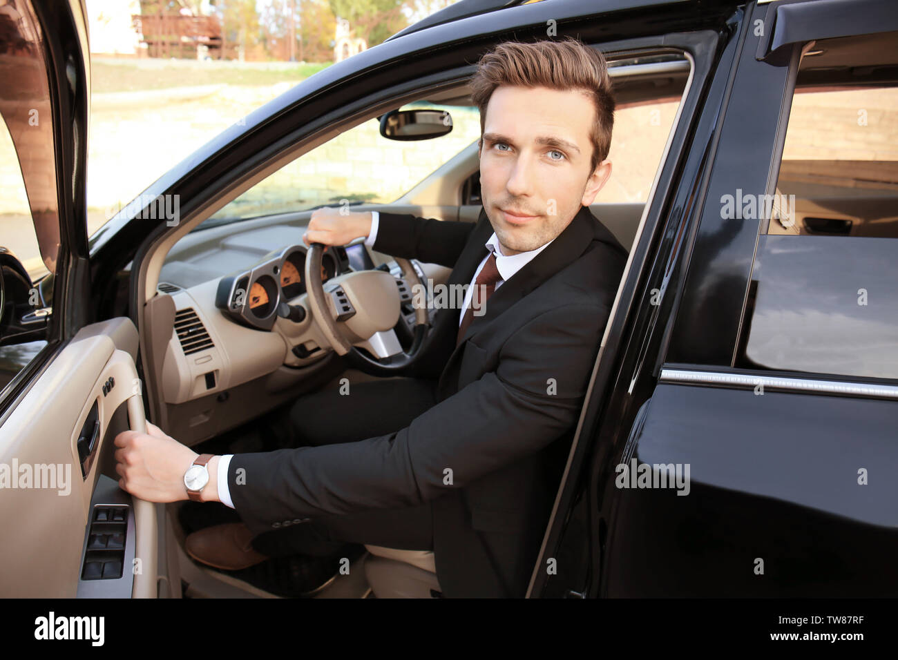 Man in formal wear getting out of car Stock Photo - Alamy