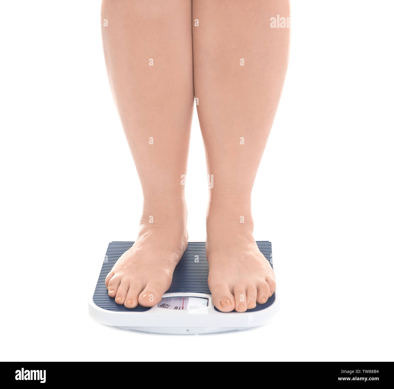Overweight woman measuring her weight using scales on white background ...