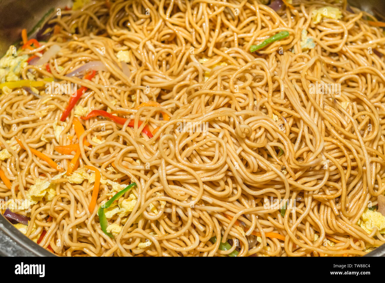 A big pot of fried noodles close-up Stock Photo - Alamy