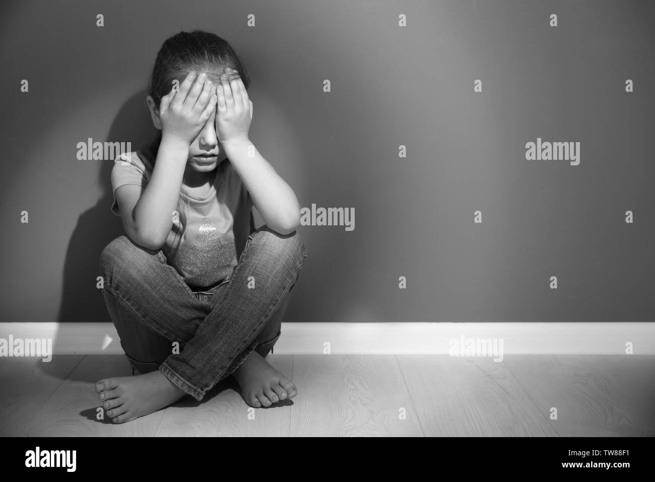 Little sad girl crying on floor. Abuse of children concept Stock Photo ...