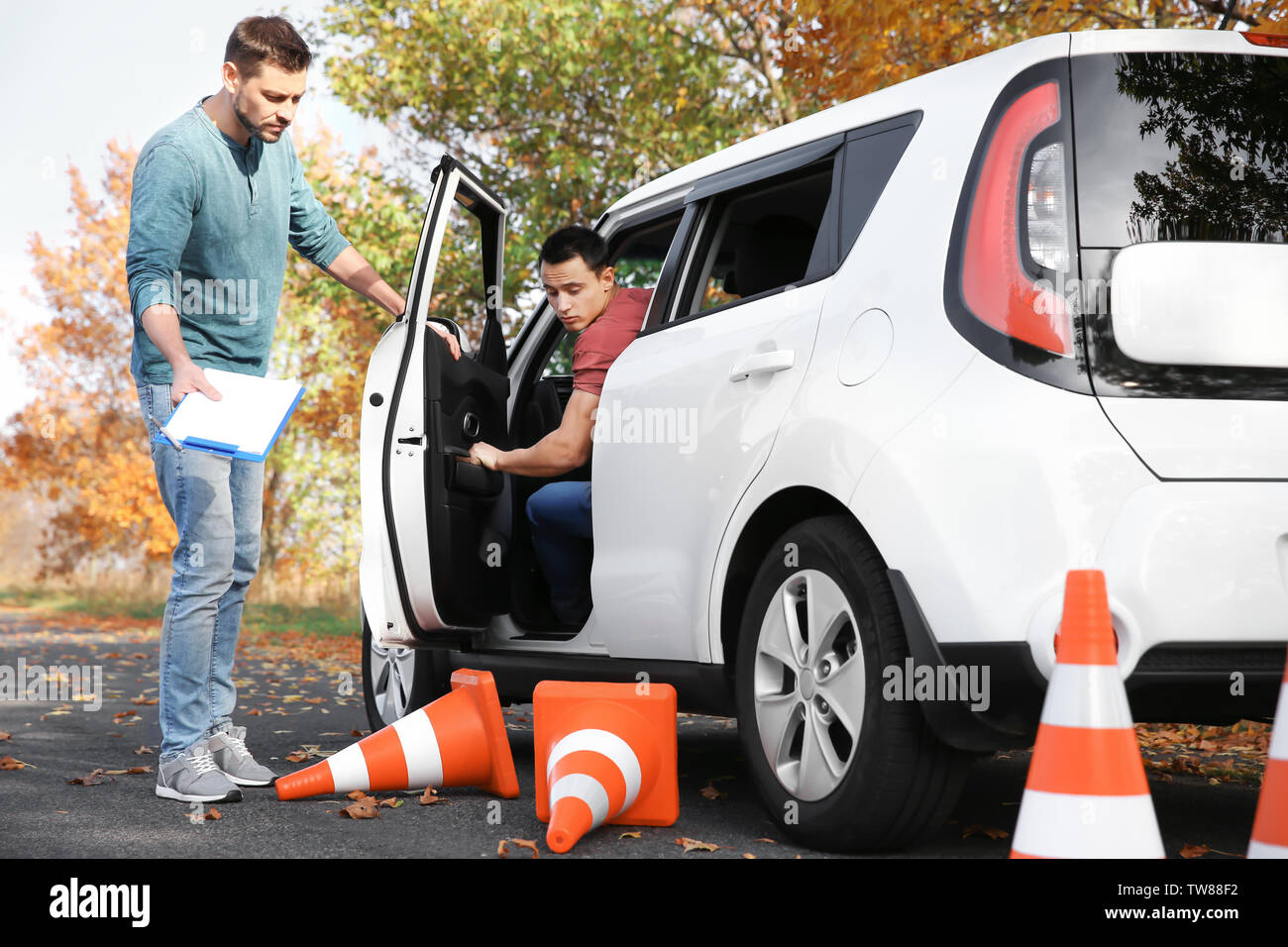 Young man passing driving license exam Stock Photo - Alamy