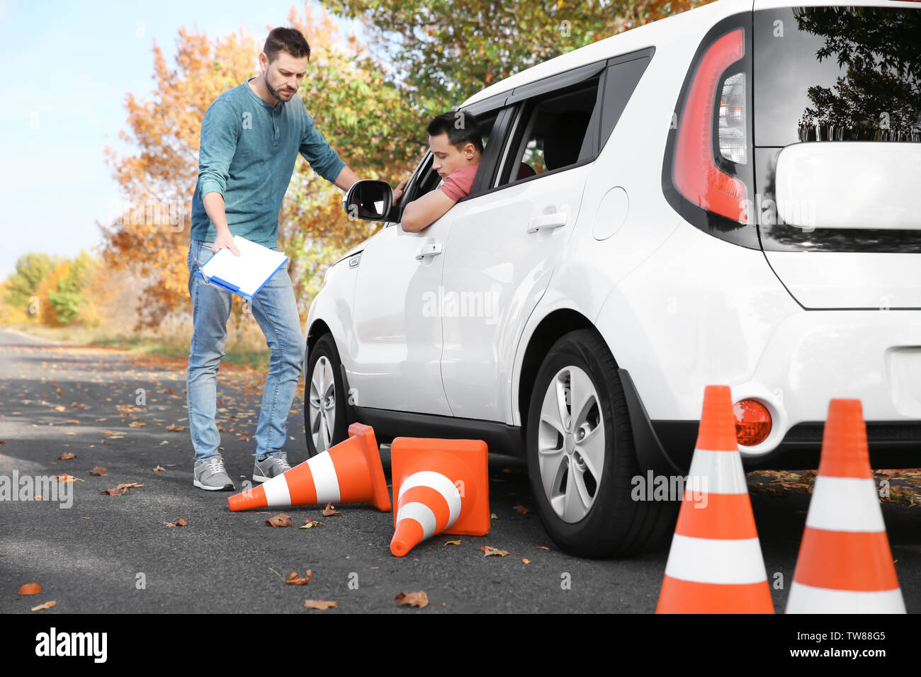 Young man passing driving license exam Stock Photo - Alamy