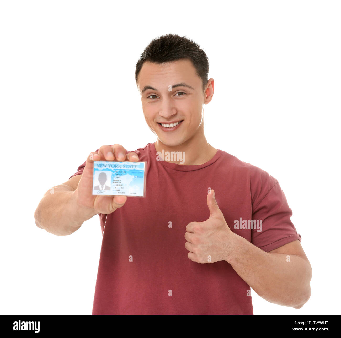 Young man holding driving license on white background Stock Photo - Alamy