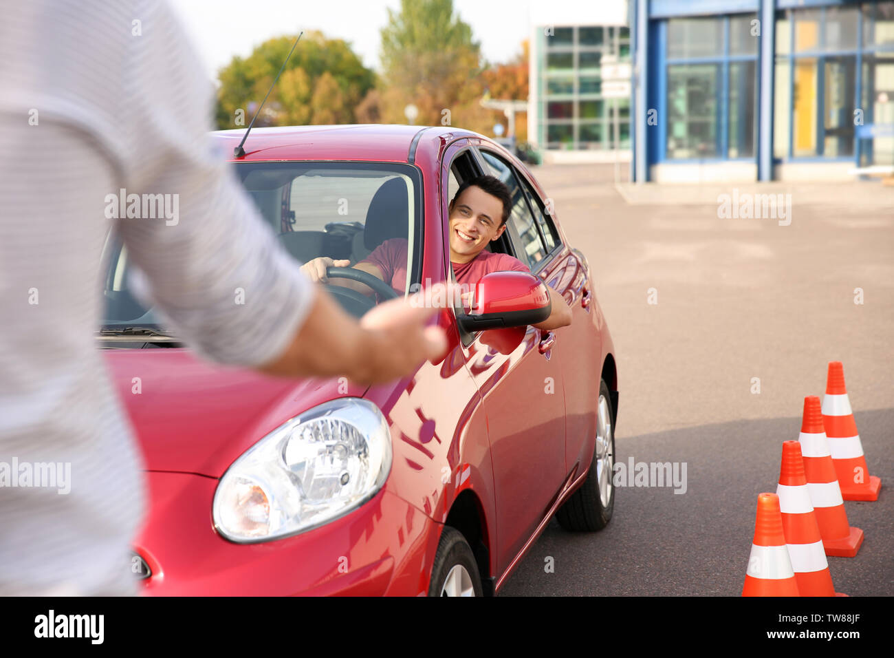 Young man passing driving license exam Stock Photo - Alamy