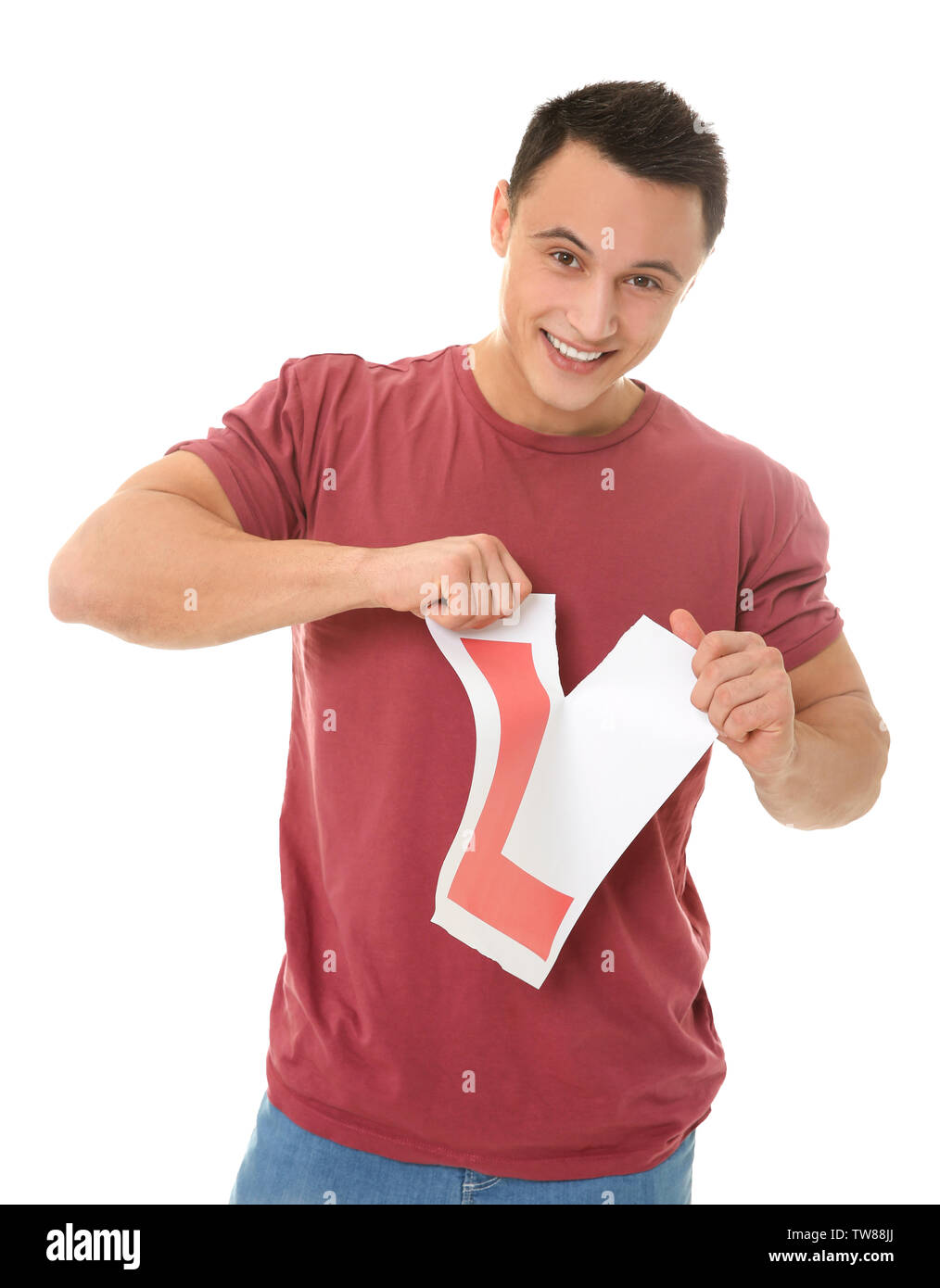Young man tearing learner driver sign on white background Stock Photo ...