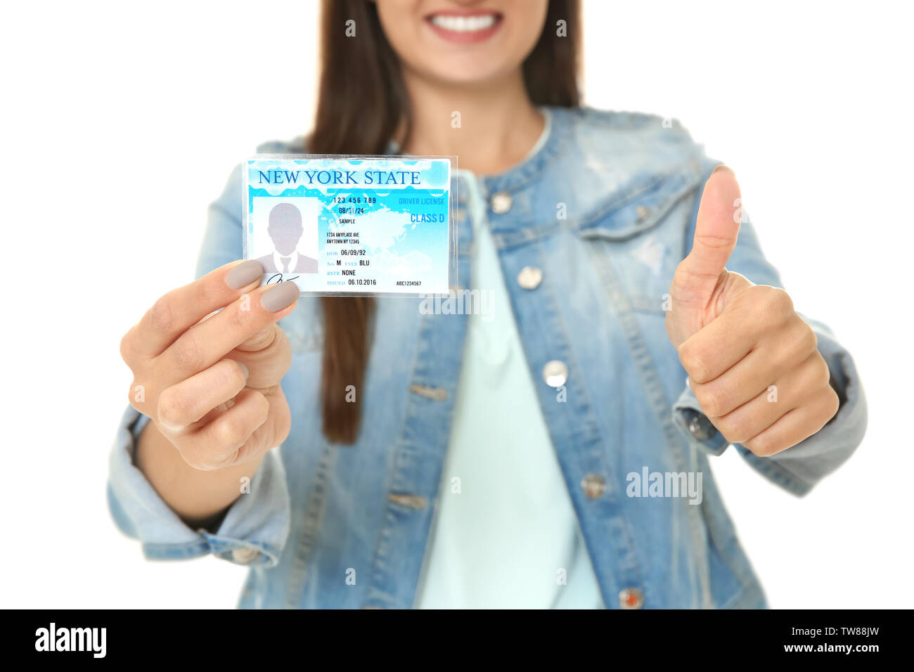 Young woman holding driving license on white background Stock Photo - Alamy