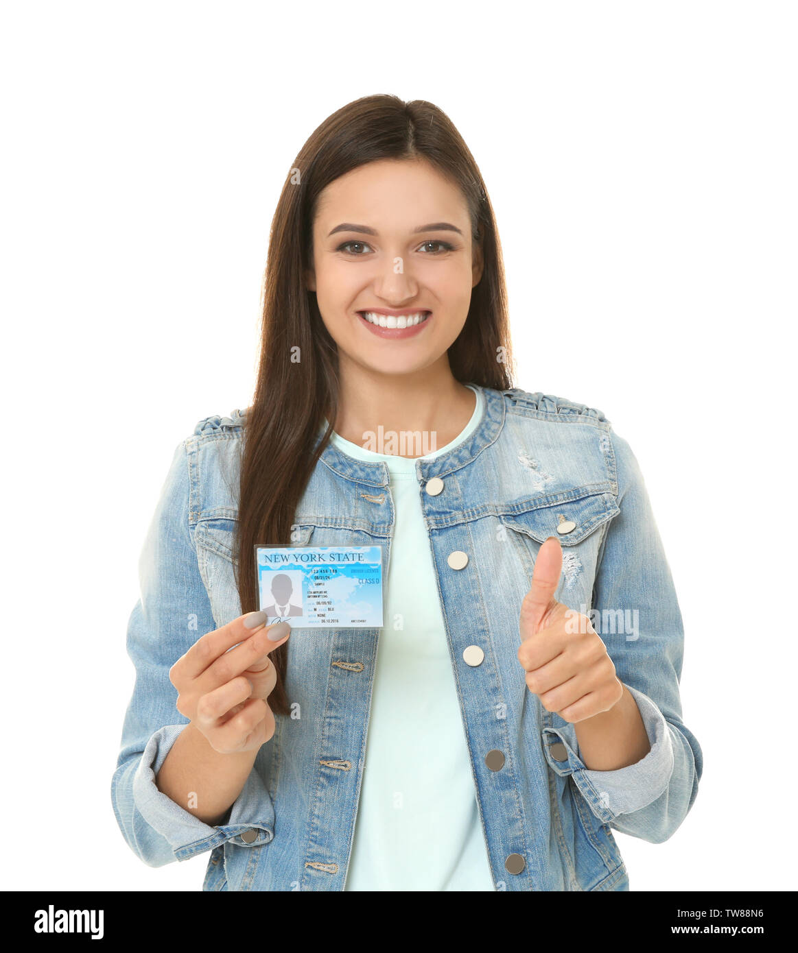 Young woman holding driving license on white background Stock Photo - Alamy