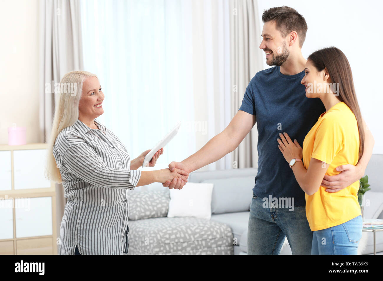 Female insurance agent consulting young couple in office Stock Photo ...