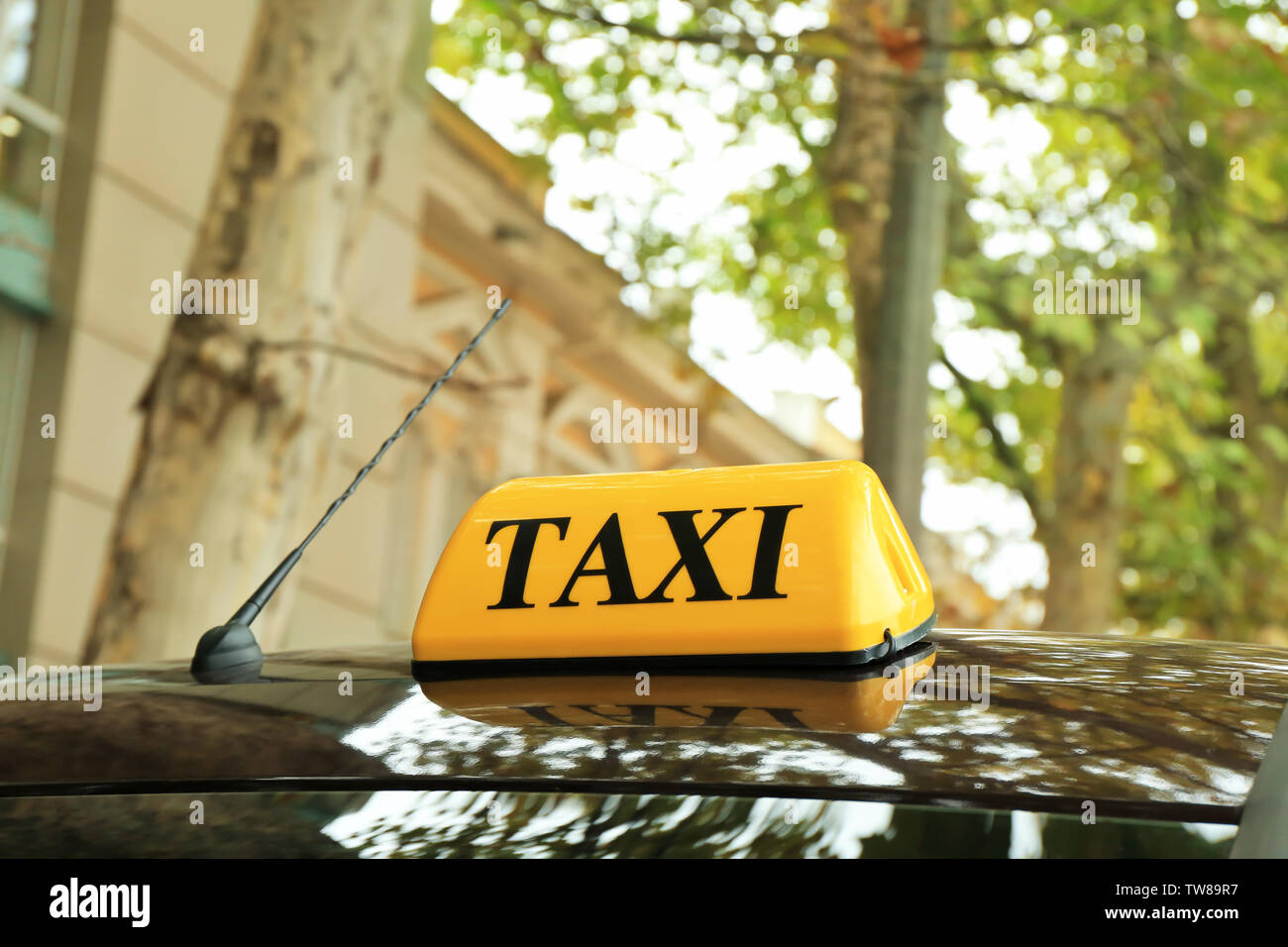 Yellow taxi roof sign on car outdoors Stock Photo - Alamy