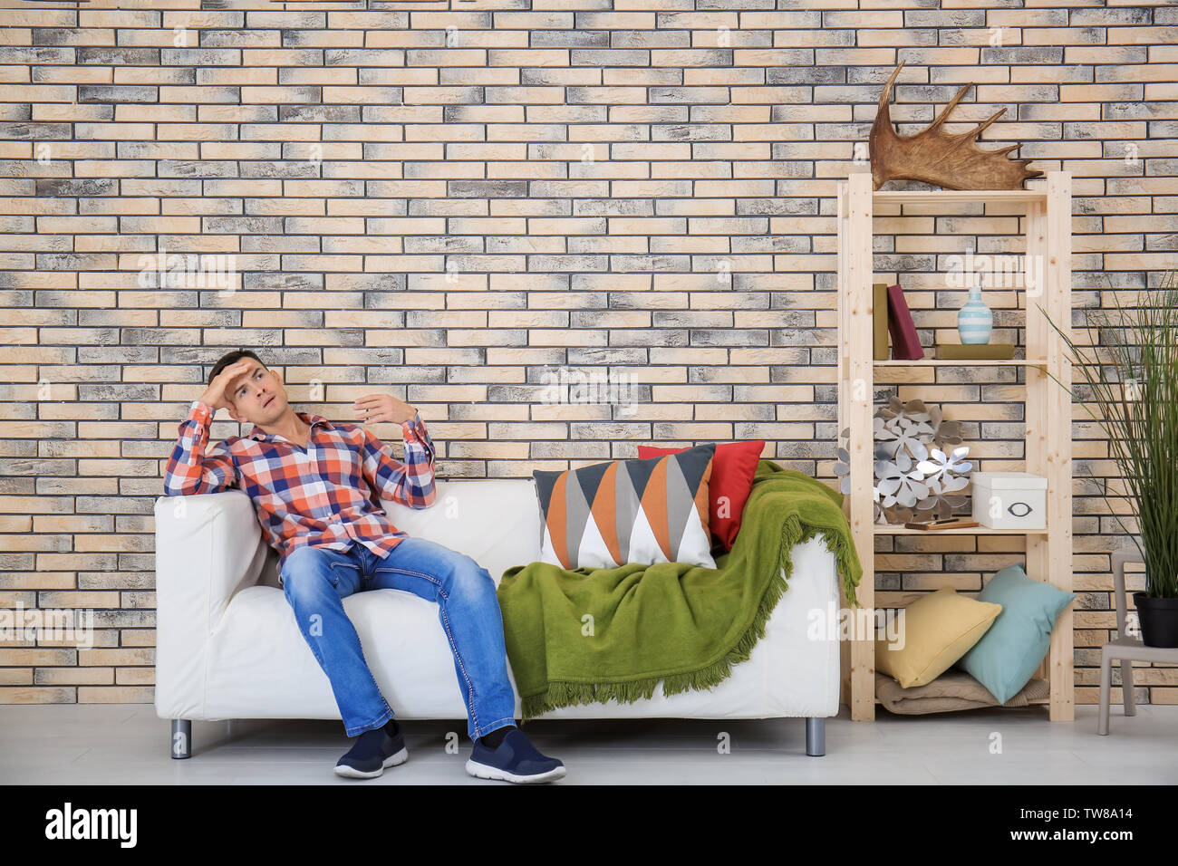Young man feeling hot at home Stock Photo - Alamy