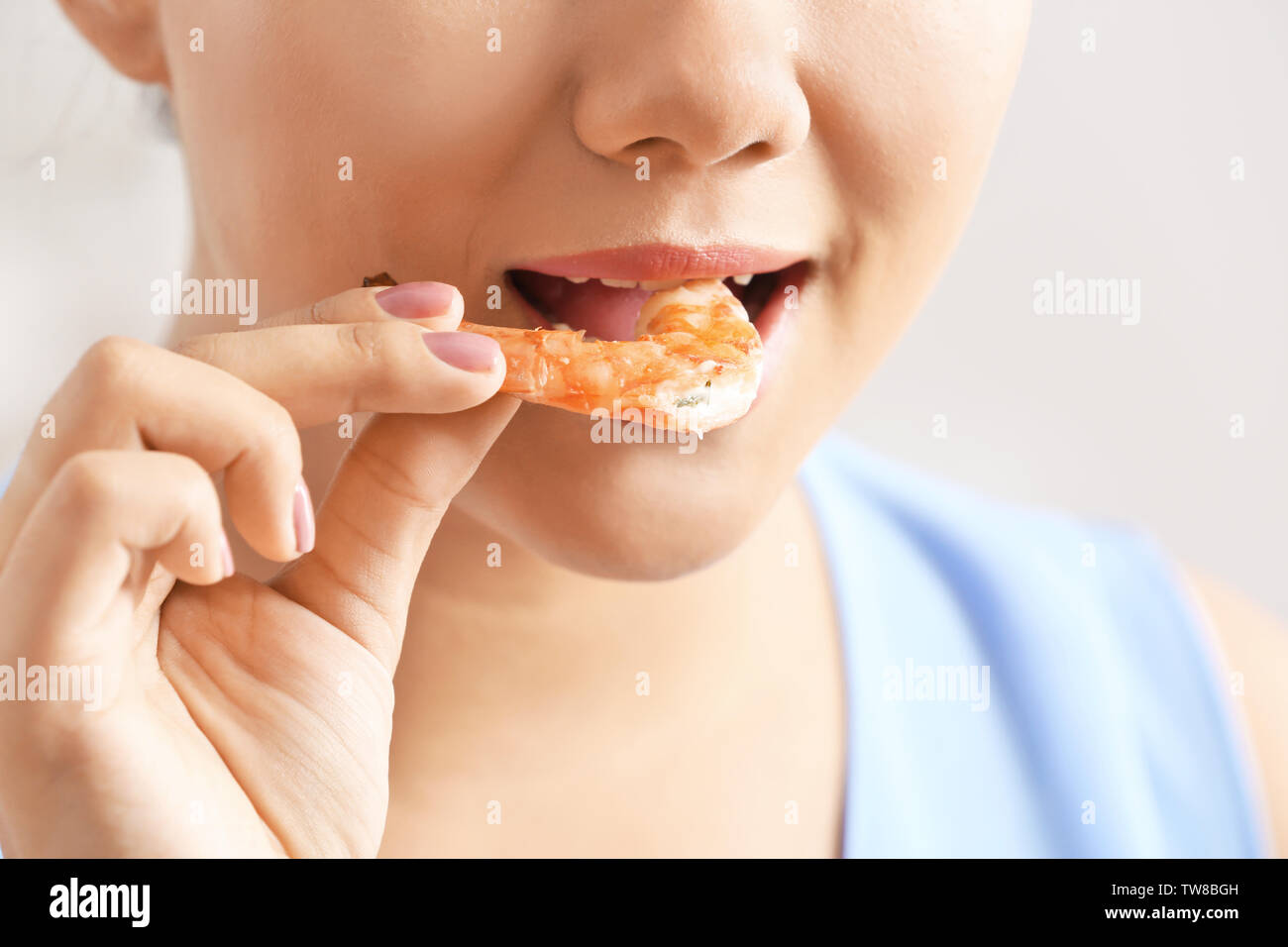 Beautiful woman eating shrimp, closeup Stock Photo - Alamy