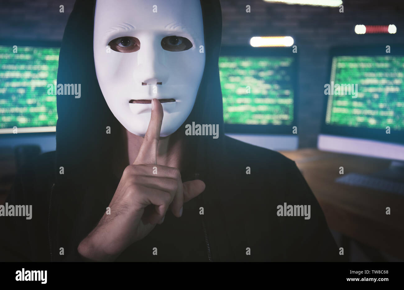Masked hacker in dark room with computers. Threat of cyber attack Stock ...