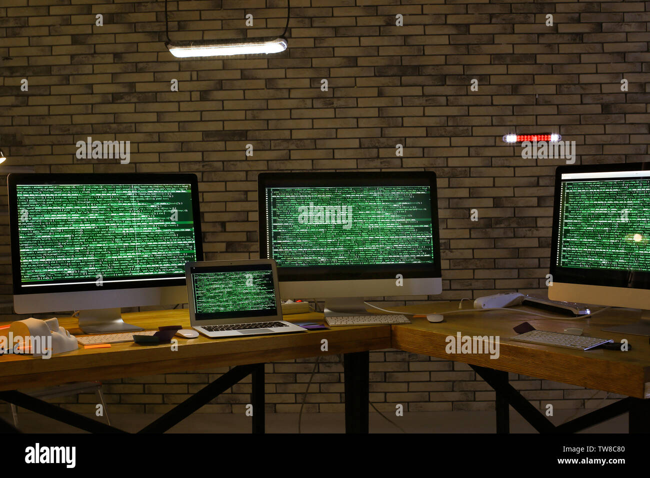 Hacker's workplace with monitors in dark room. Threat of cyber attack ...