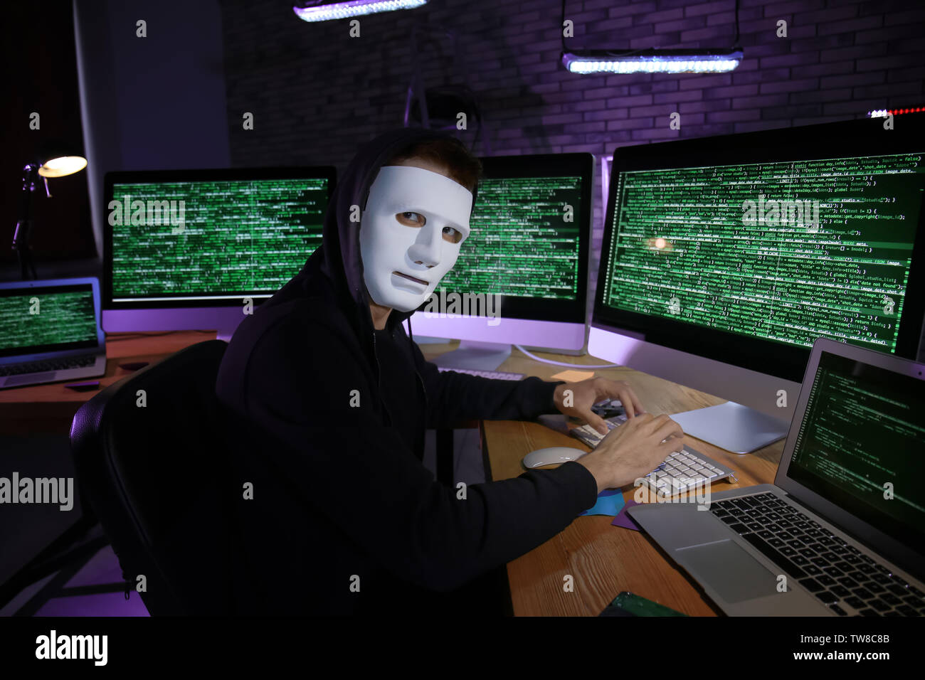 Masked hacker using computer in dark room. Threat of cyber attack Stock ... Masked hacker using computer in dark room. Threat of cyber attack Stock ...
