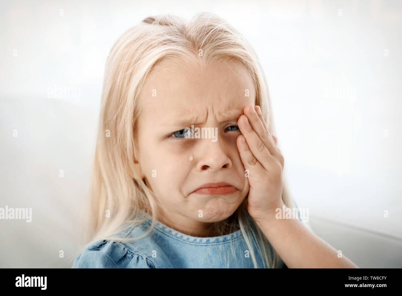 Helpless little girl crying indoors. Child abuse concept Stock Photo ...