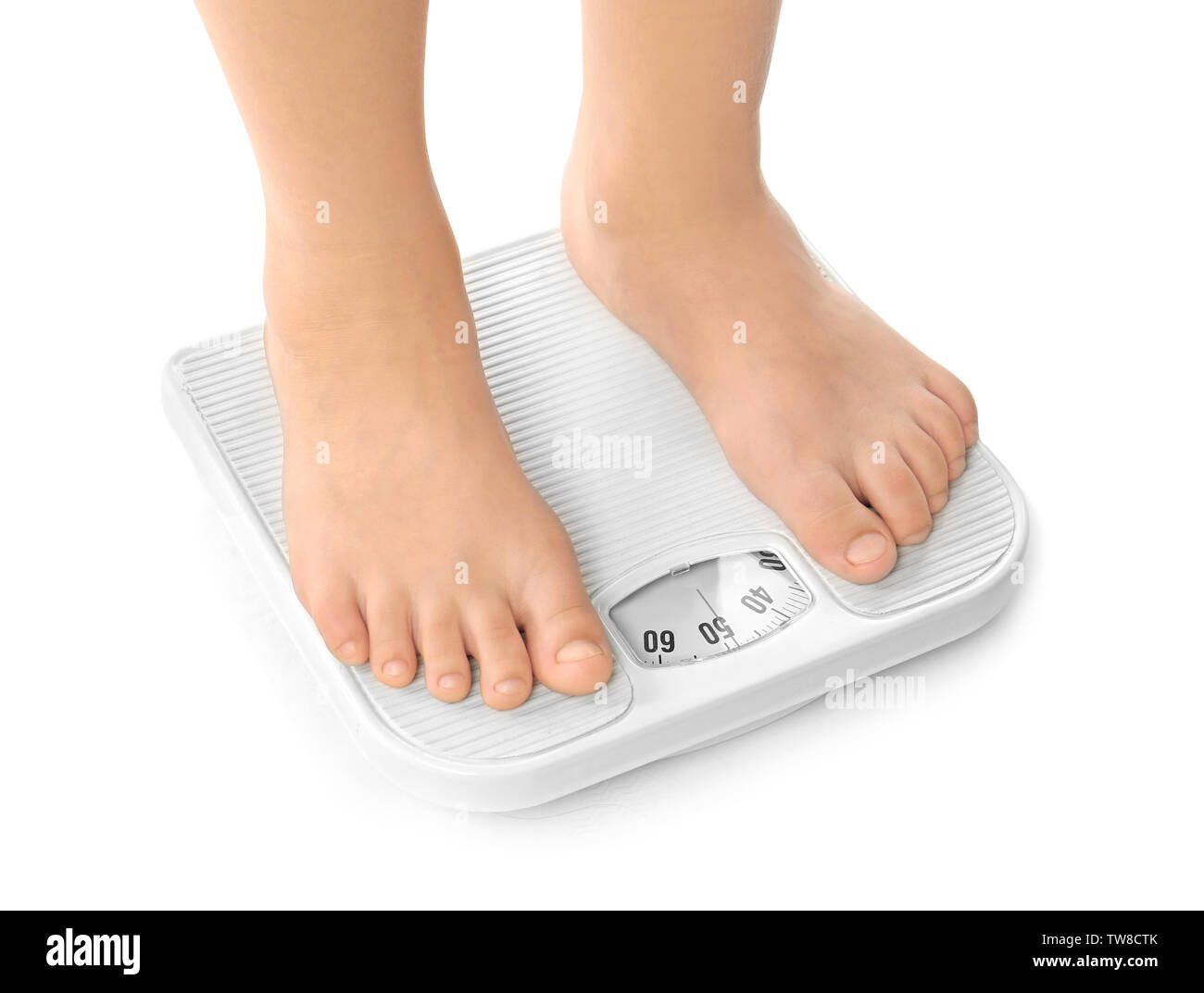 Legs of overweight boy using scales on white background Stock Photo - Alamy