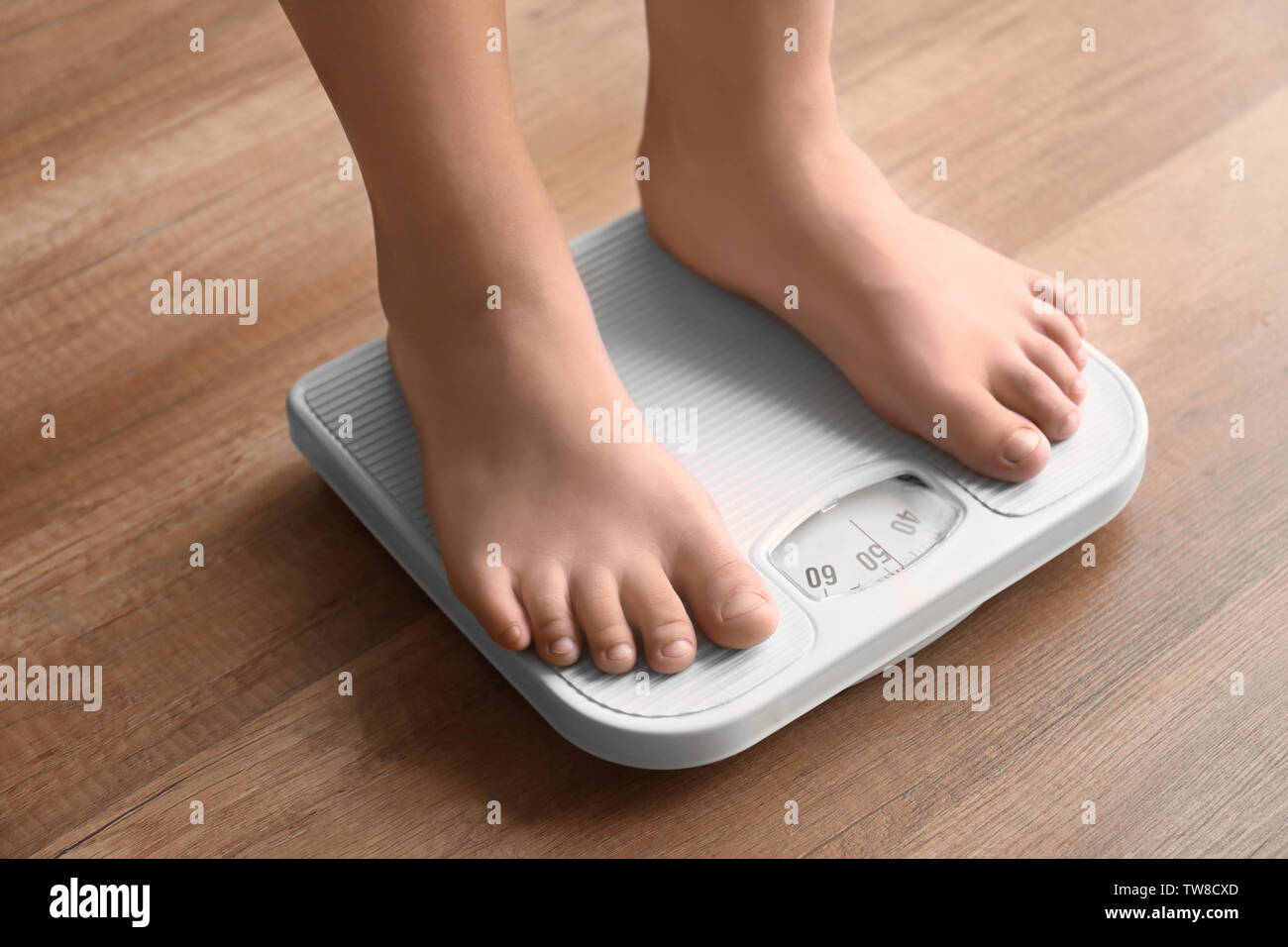 Fat child boy scales hi-res stock photography and images - Alamy