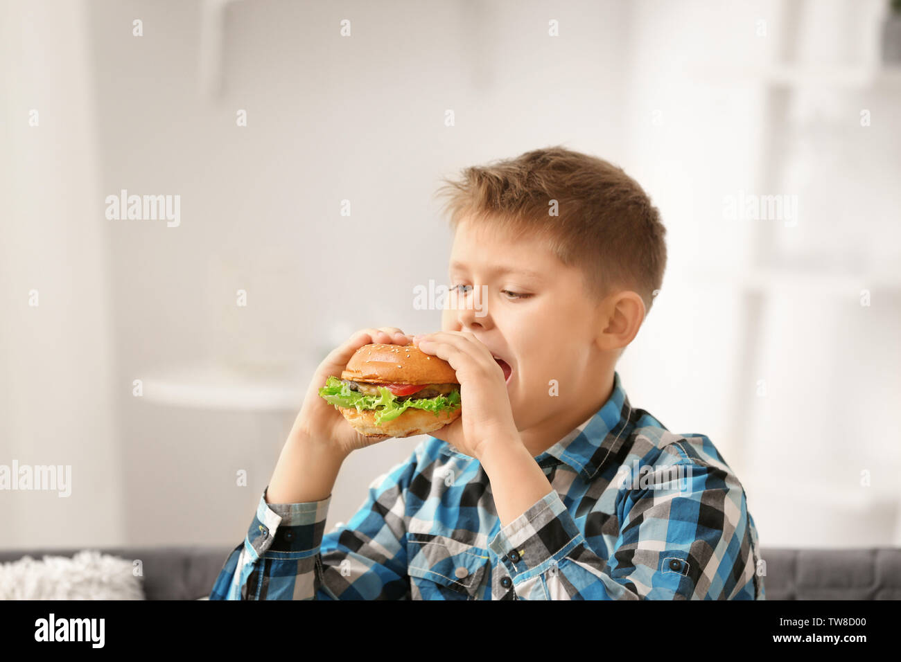 Overweight child eating junk food hi-res stock photography and images ...