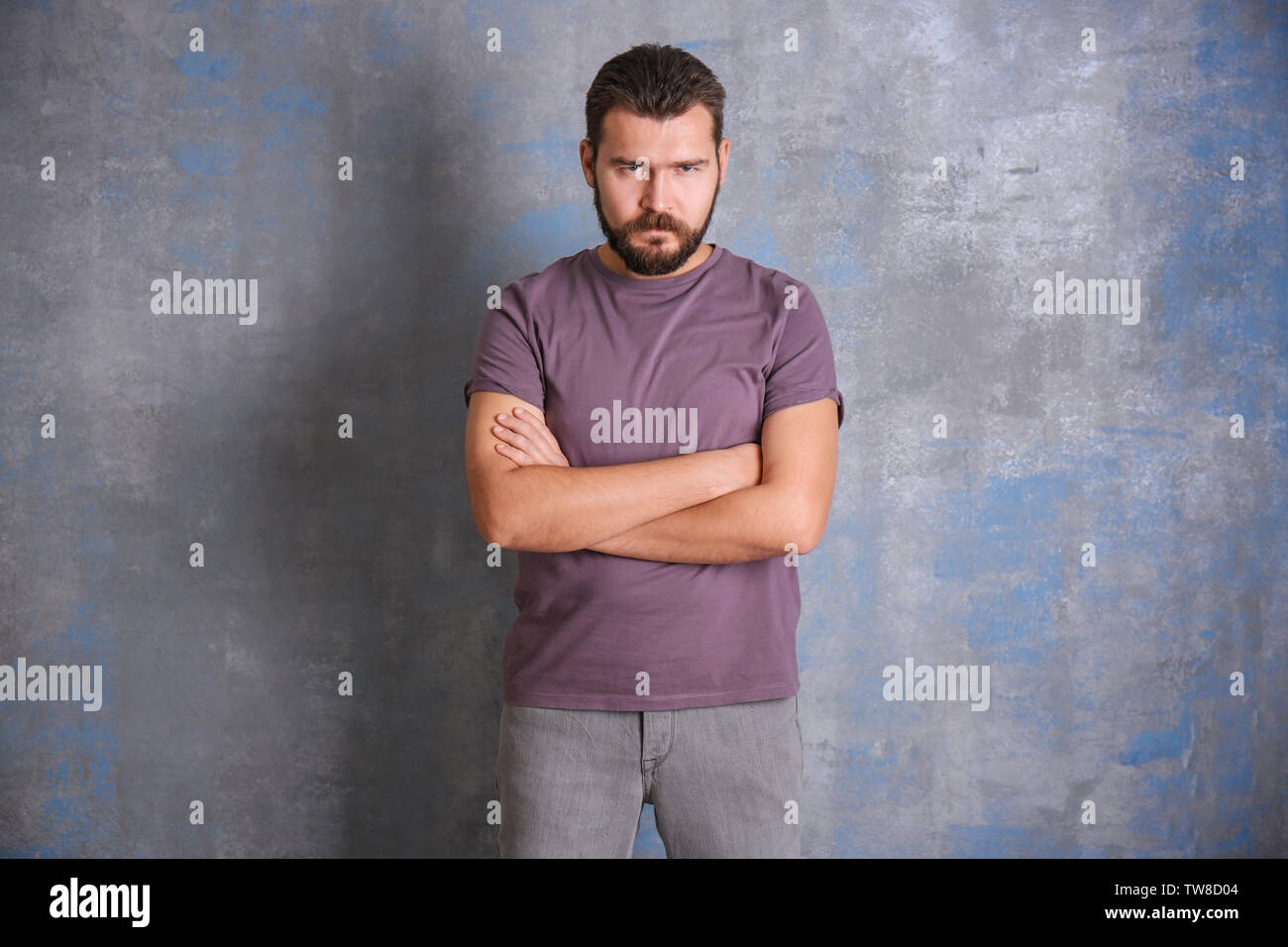 Portrait of angry man near color wall Stock Photo - Alamy