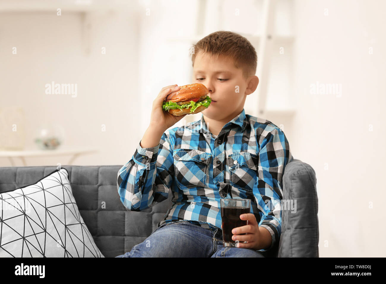 Overweight child eating junk food hi-res stock photography and images ...