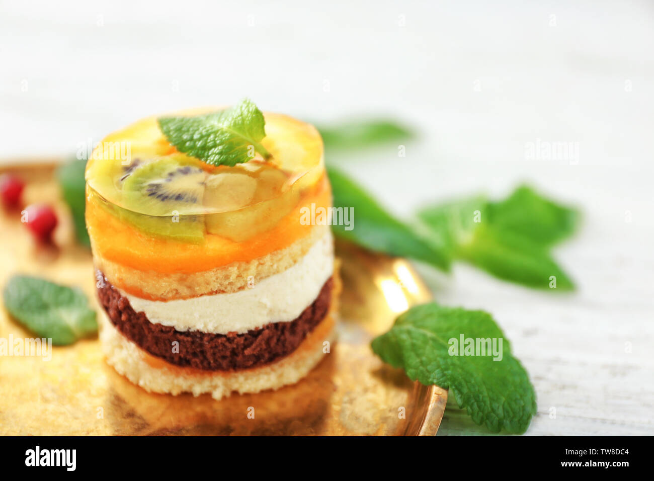 Tray with tasty fruit sponge cake on table Stock Photo - Alamy