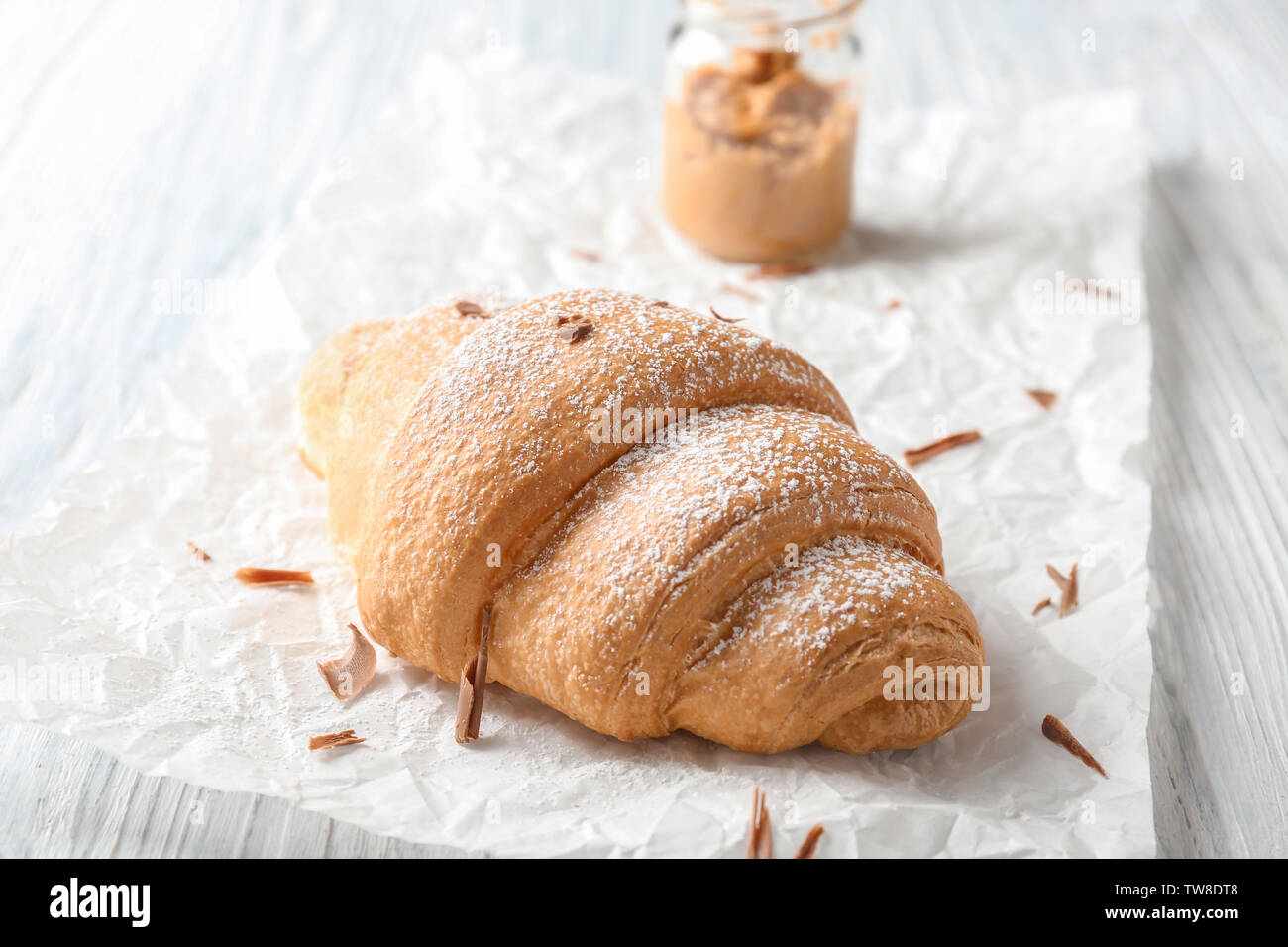 Fresh yummy croissant on parchment paper Stock Photo - Alamy
