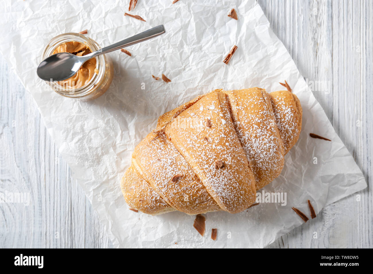 Fresh yummy croissant on parchment paper Stock Photo - Alamy