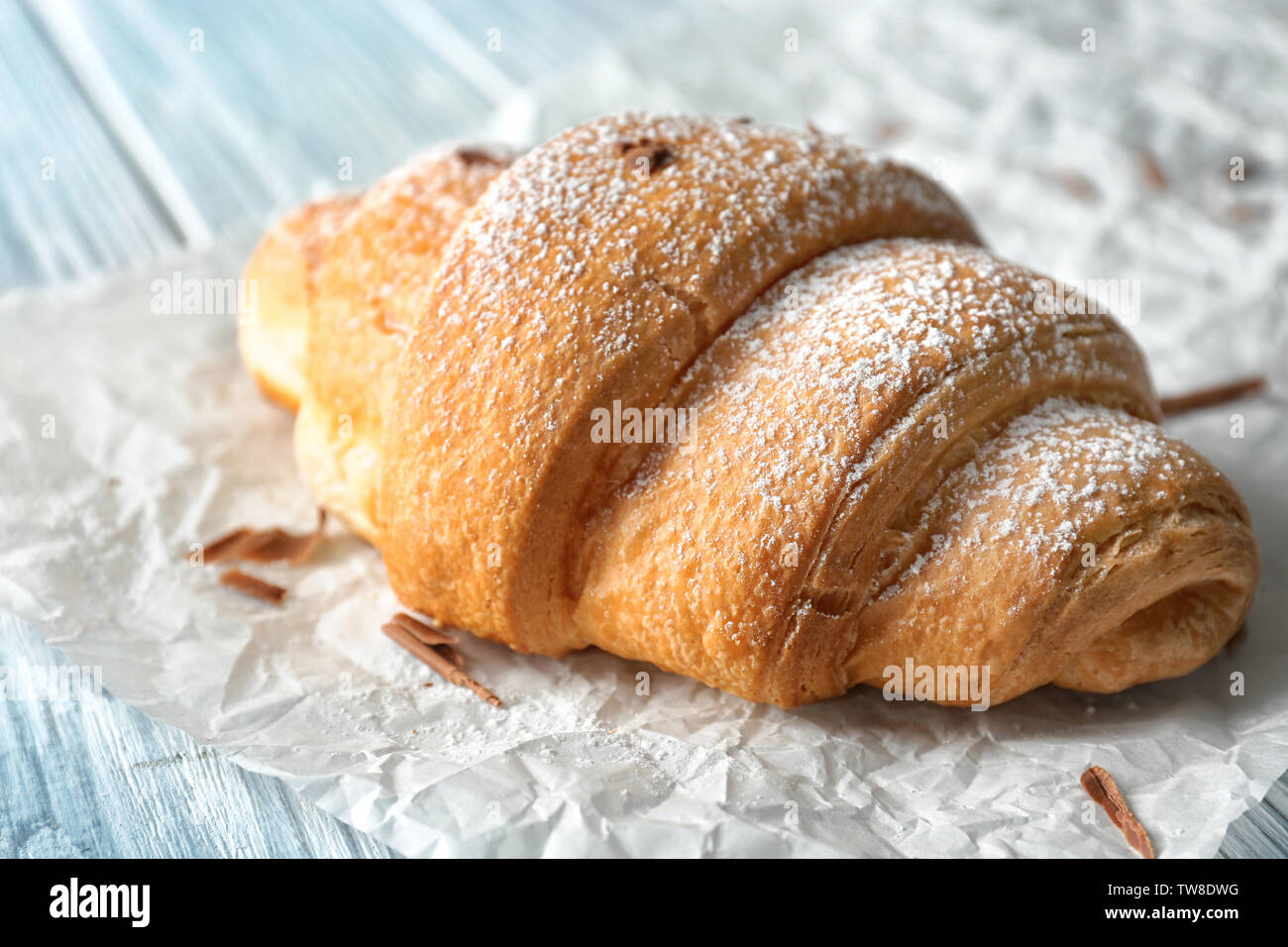 Fresh yummy croissant on parchment paper Stock Photo - Alamy