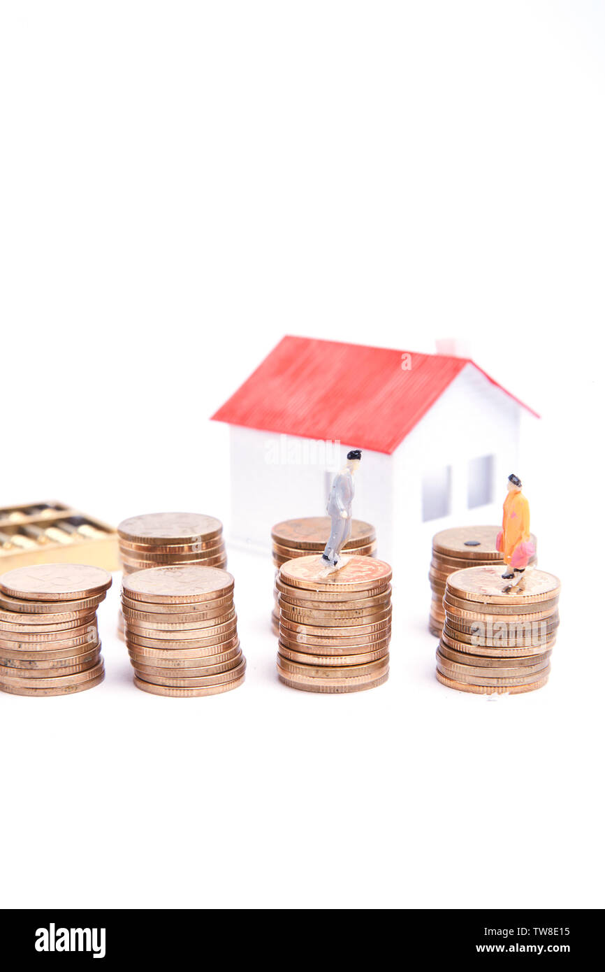 Coin house model and couple on white background Stock Photo - Alamy