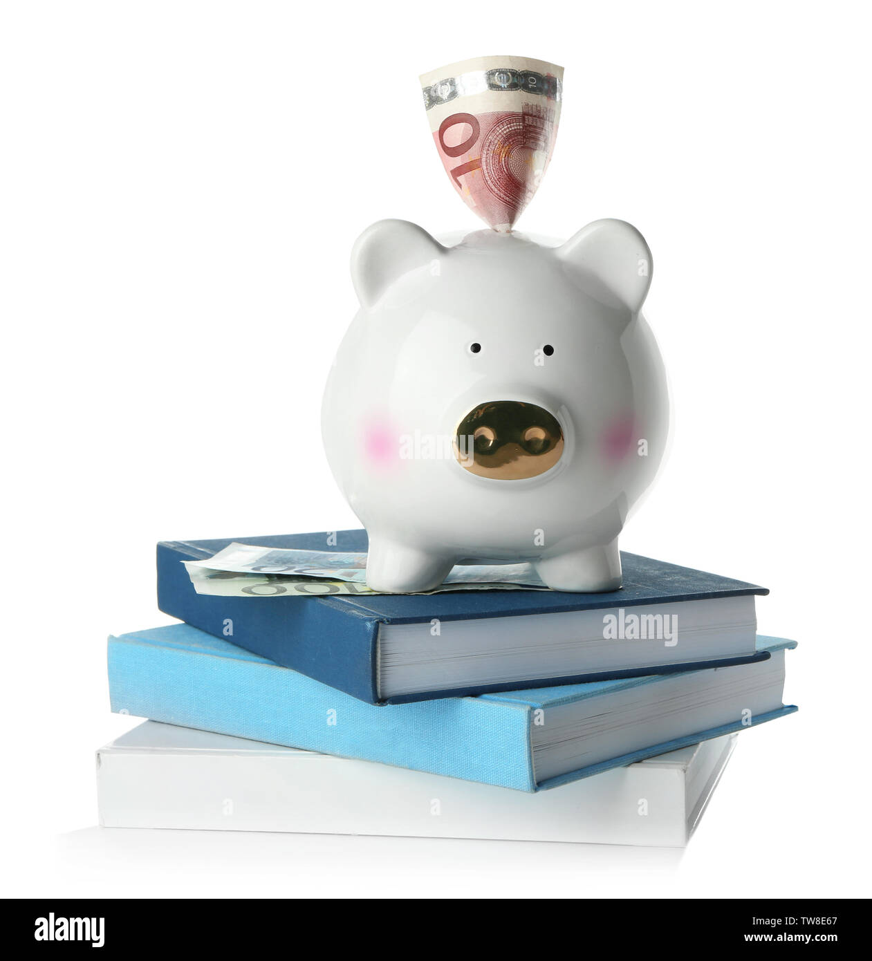 Piggy bank with banknotes and stack of books on white background ...