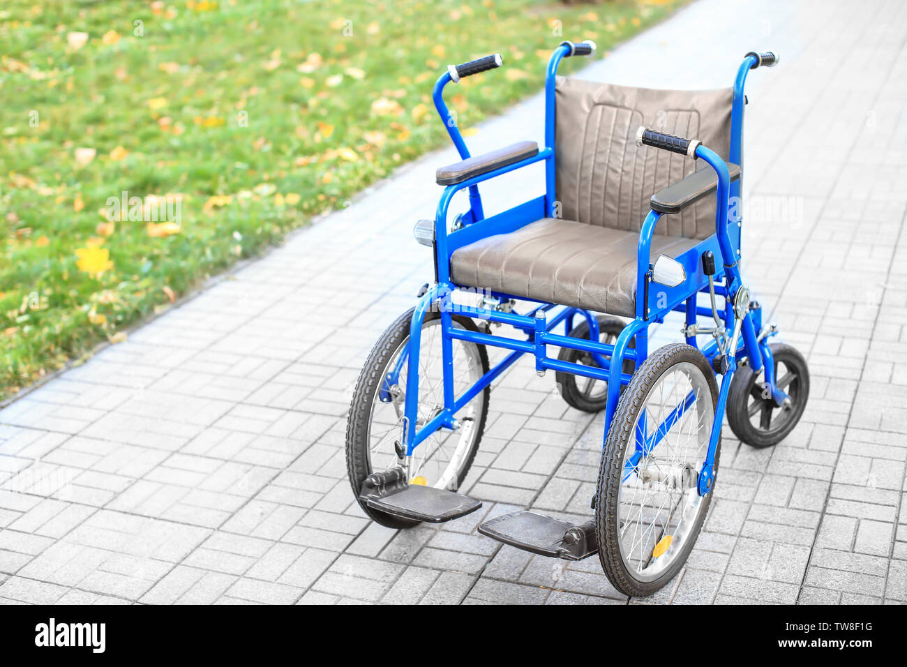 Blue wheelchair outdoors on sunny day Stock Photo - Alamy
