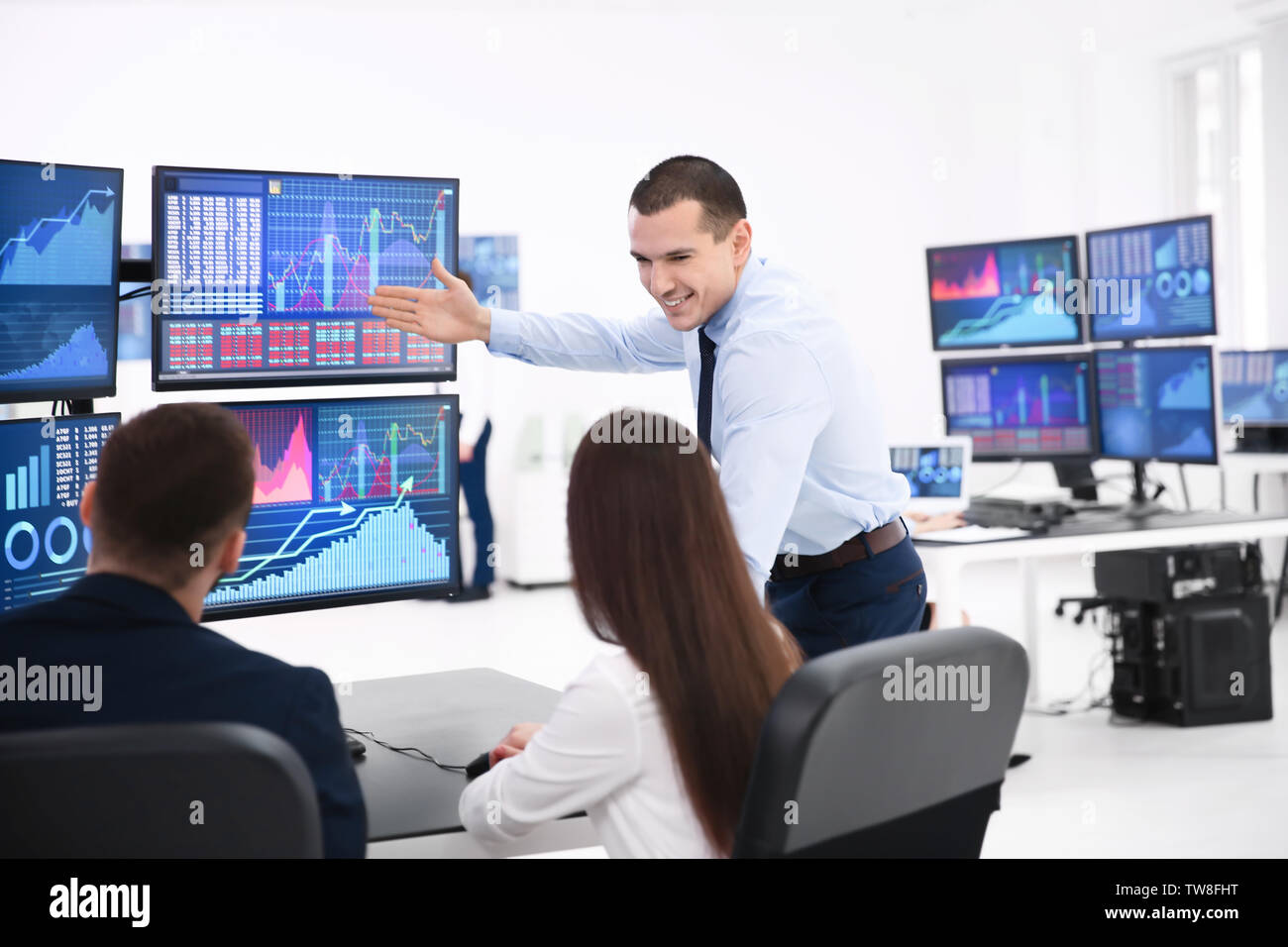 Stock traders working in office Stock Photo - Alamy